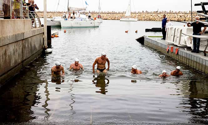 Israeli swimmers battle plastic bags to take open water record | World News