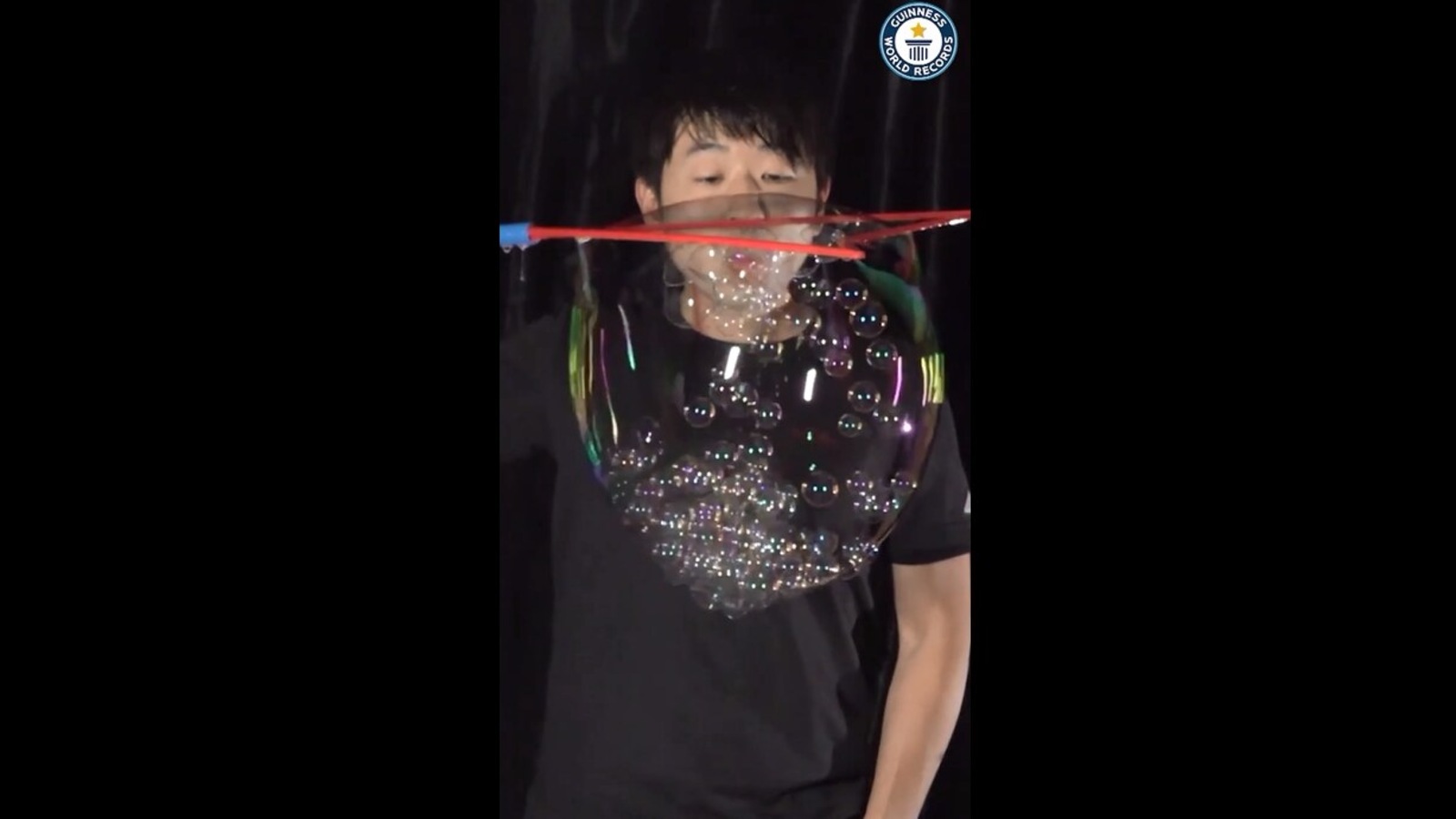 Man blows small bubbles inside a huge bubble. Video shows incredible ...