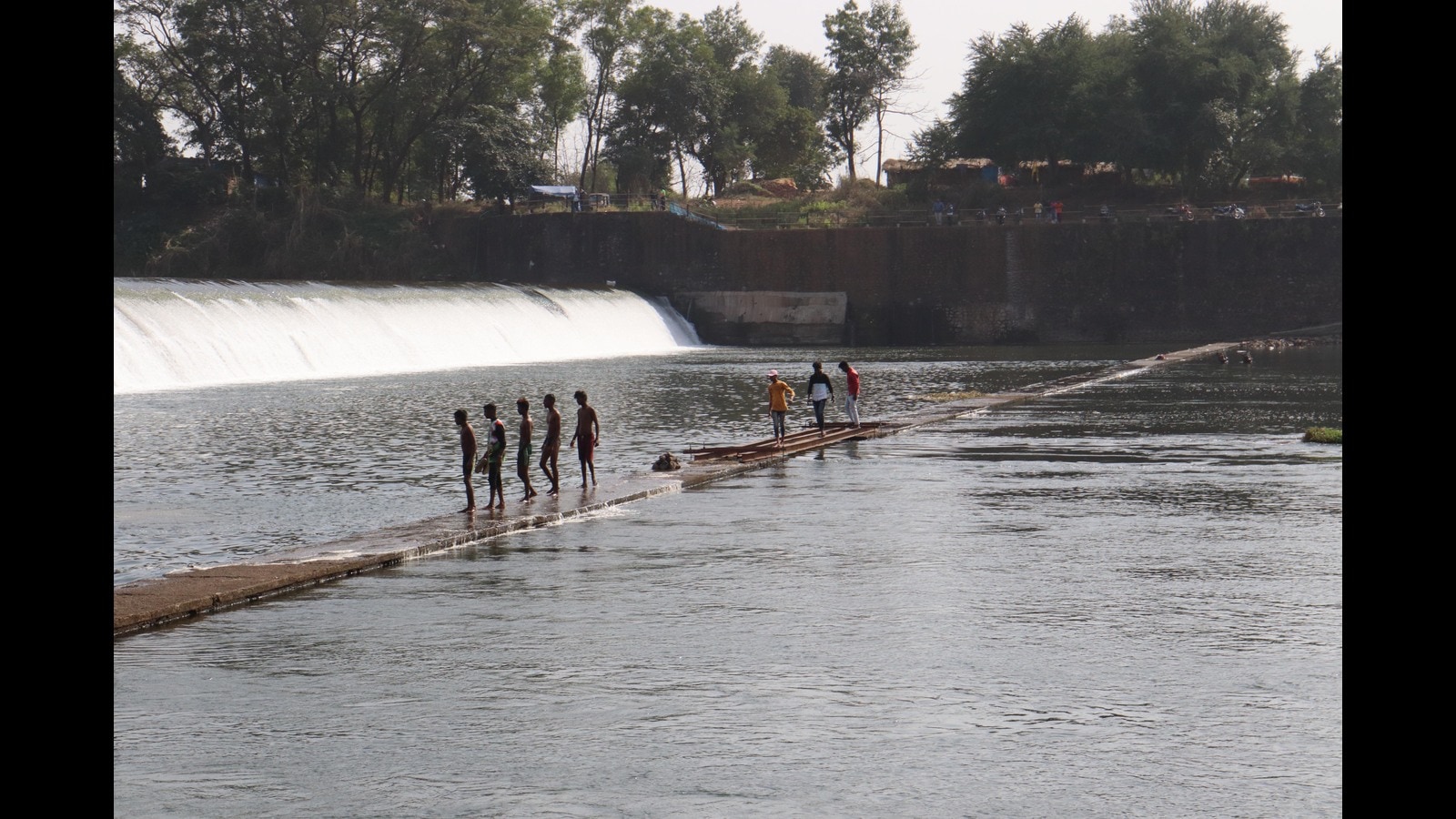 With no bridge, villagers forced to use rickety path to cross dam in ...