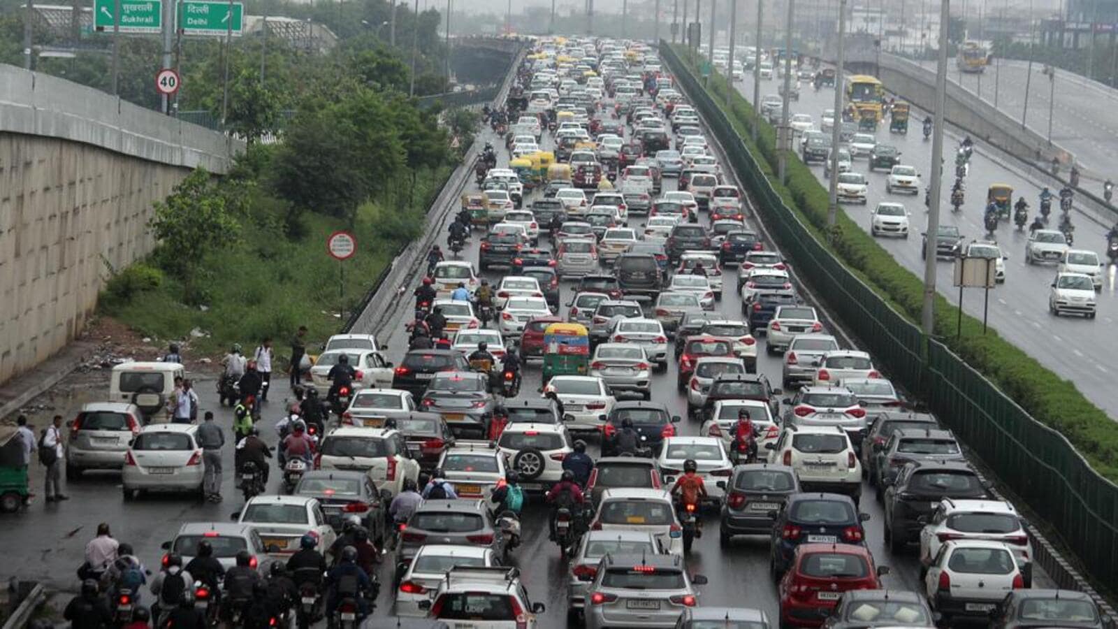 Aftermath of the rain: Potholes, water logging cause traffic jams in ...