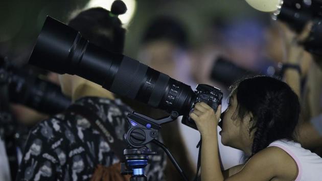 Photos | A lunar trifecta: Gazers watch super blue blood moon ...