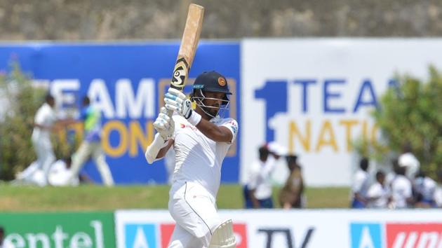Sri Lanka’s Dimuth Karunaratne carries his bat as Kagiso Rabada puts ...