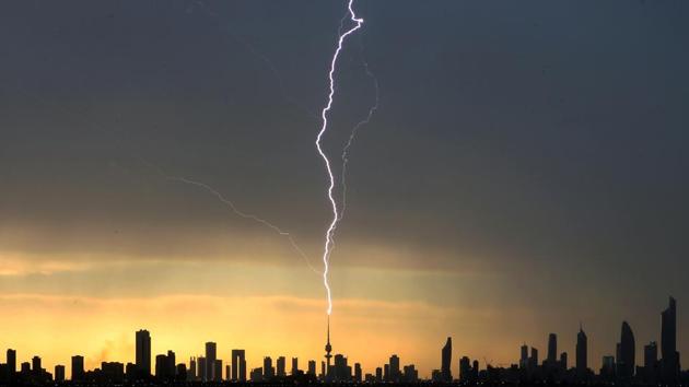 Lighting above Kuwait City and a tightrope walker in Prague: Photos of ...