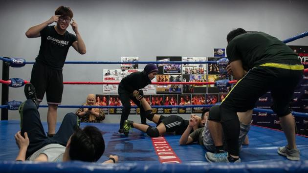 Photos: A hijab-wearing wrestler breaks barriers in Malaysia ...