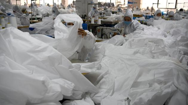 Photos: In virus-hit China, coat maker adapts to make hazmat suits ...