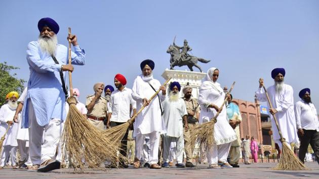 SGPC chief leads panel members in sweeping Heritage Street leading to Golden Temple as ...