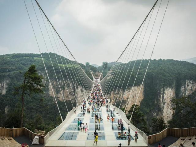 Walking on this glass-bridge is one scary trip. Anyone up for it ...