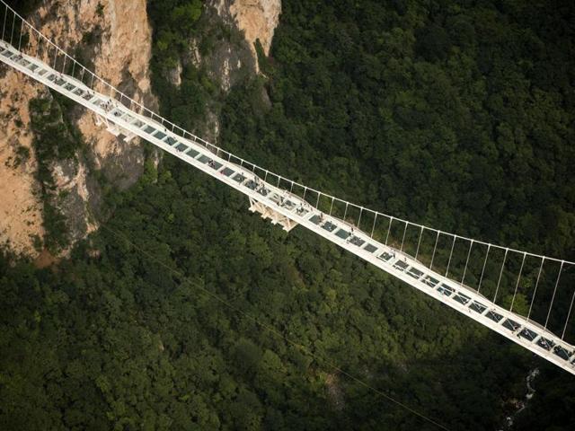 Walking on this glass-bridge is one scary trip. Anyone up for it ...