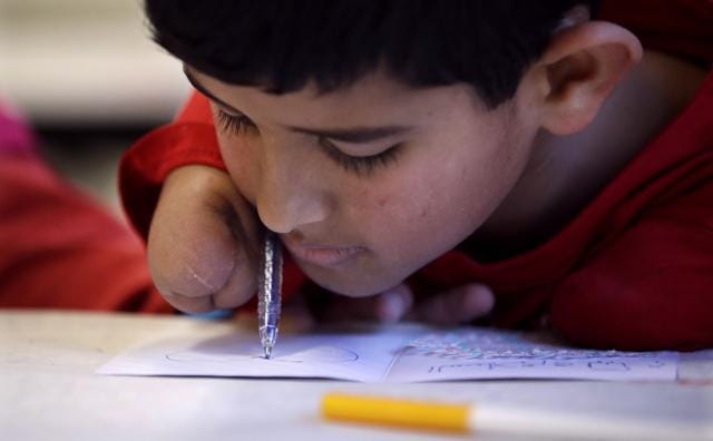 Armless Syrian boy thrives in the US, hopes family can join him | World ...