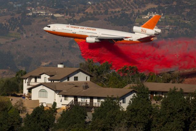 In pics: California wildfires force 120,000 to flee as blazes tear ...