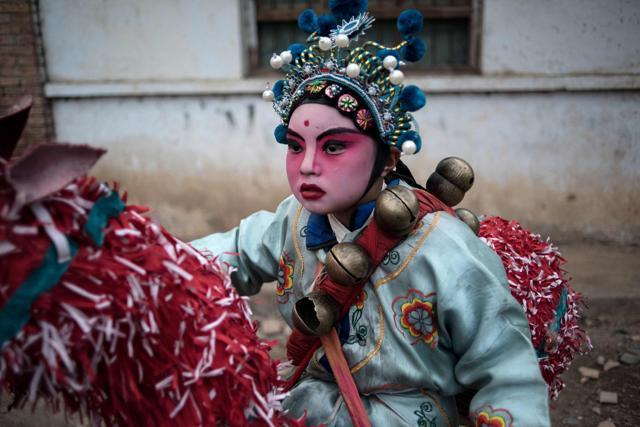 Chinese villagers don robes, make-up and wield swords to celebrate ...