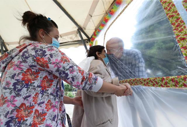 Hug curtain installed at Belgian retirement home for safe embrace ...