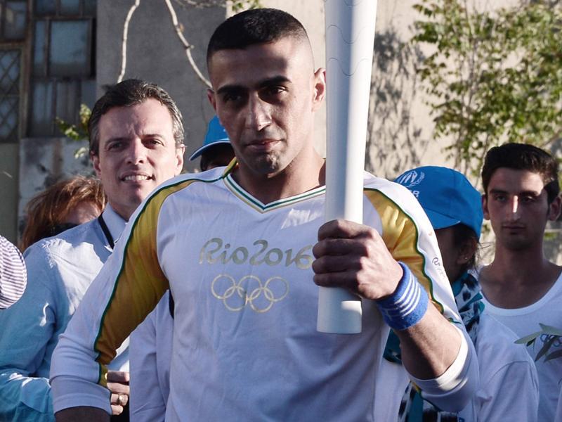 Syrian athlete carries Rio 2016 flame through Athens refugee camp ...