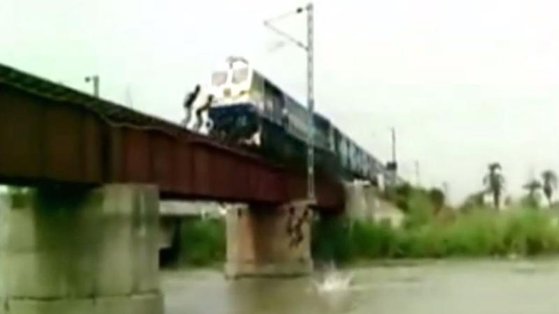 Watch | Young boys jump off bridge seconds before train passes through ...