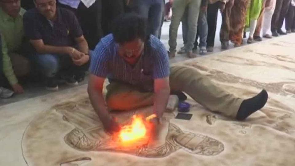 Indian artist uses fire to make paintings, eyes world record ...