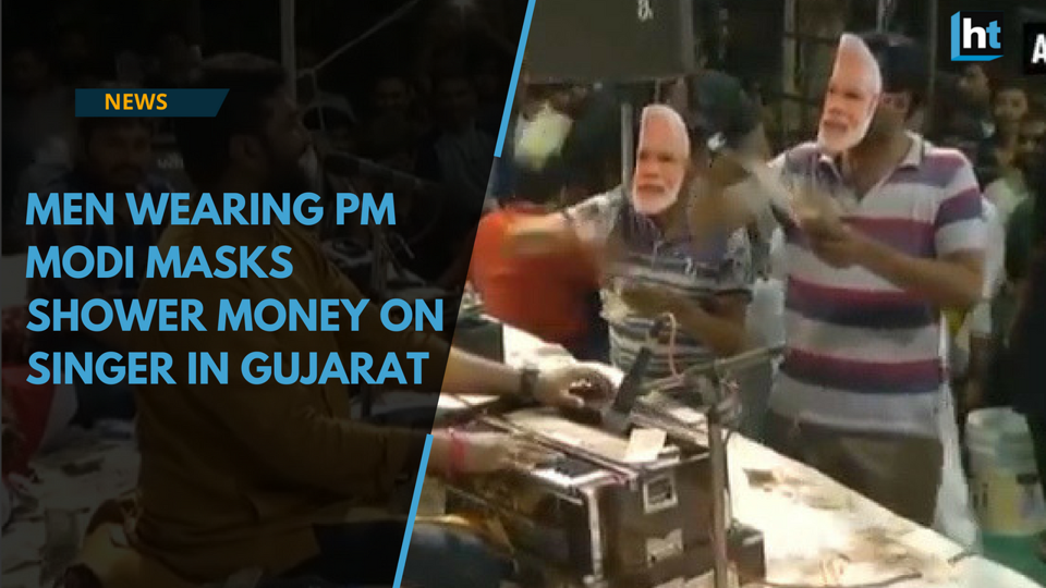 Watch: Men wearing PM Modi masks shower money on singer in Ahmedabad ...