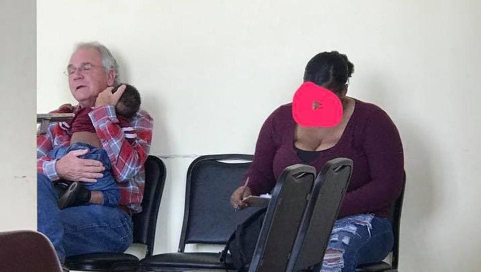 Stranger holds sleeping baby so mom can fill up forms, moving pic goes ...
