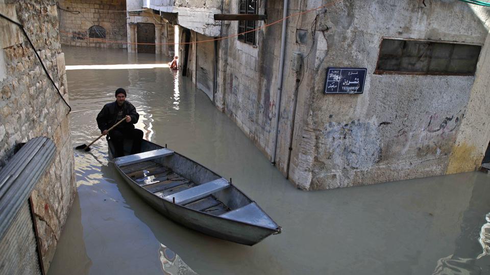 Photos: Farmer turns ferryman as river engulfs Syrian hometown ...