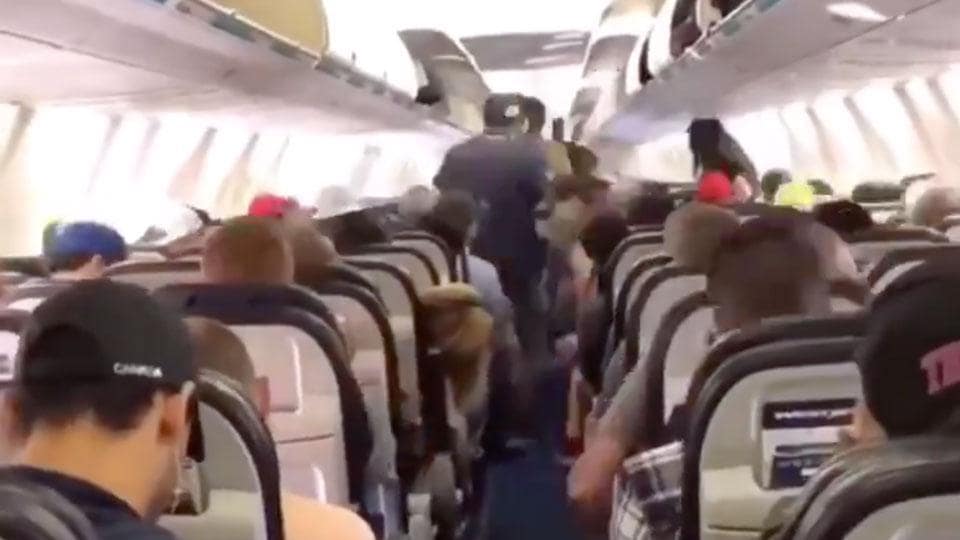 Passengers leave plane one row at a time, video goes viral | Trending ...