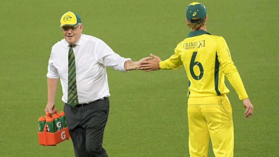 Australia PM Scott Morrison serves water to cricketers during match ...