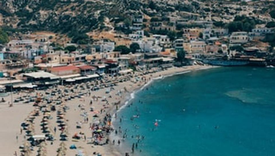 Greeks return to beaches in heatwave, but keep their umbrellas apart ...