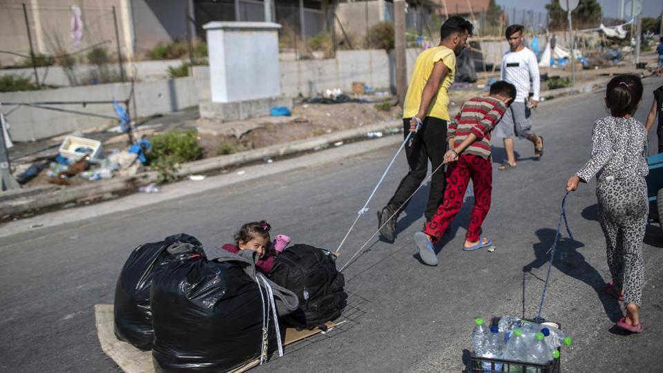 Photos: Homeless migrants in Greece moved to new camp after fire ...